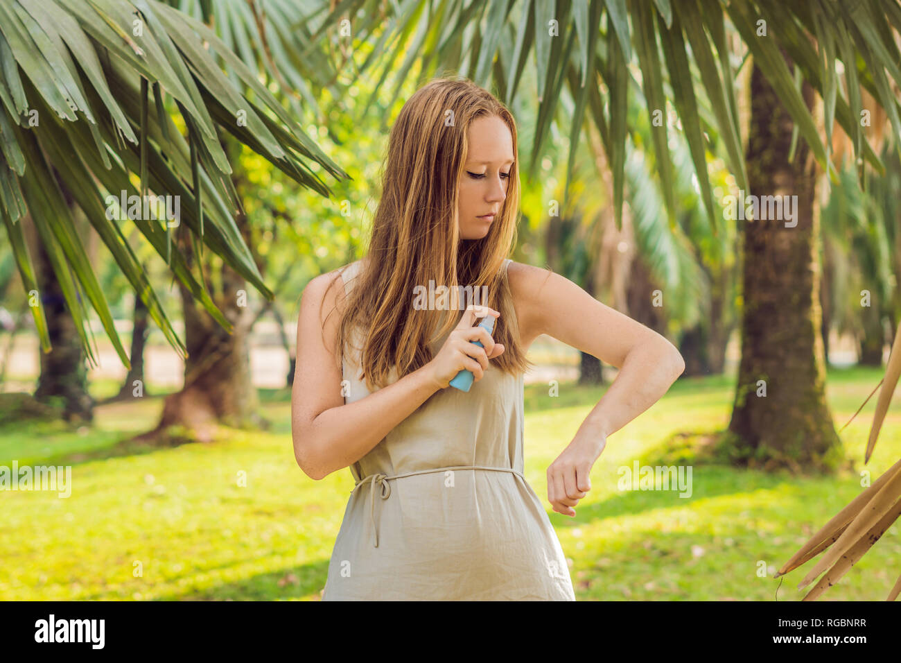 Woman spraying insect repellant hi-res stock photography and images - Alamy