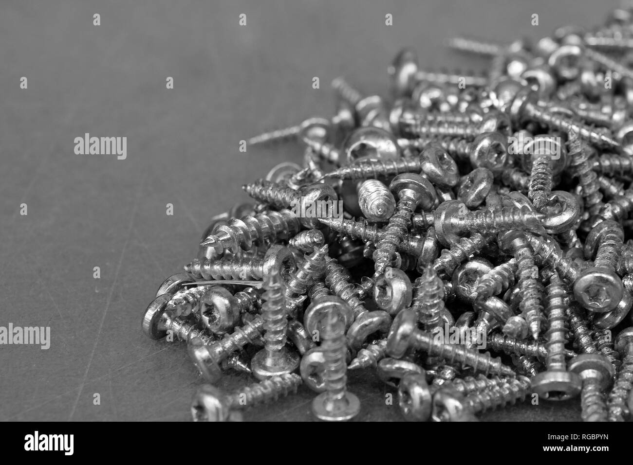 Stack of screws with copy space. Black and white Stock Photo - Alamy
