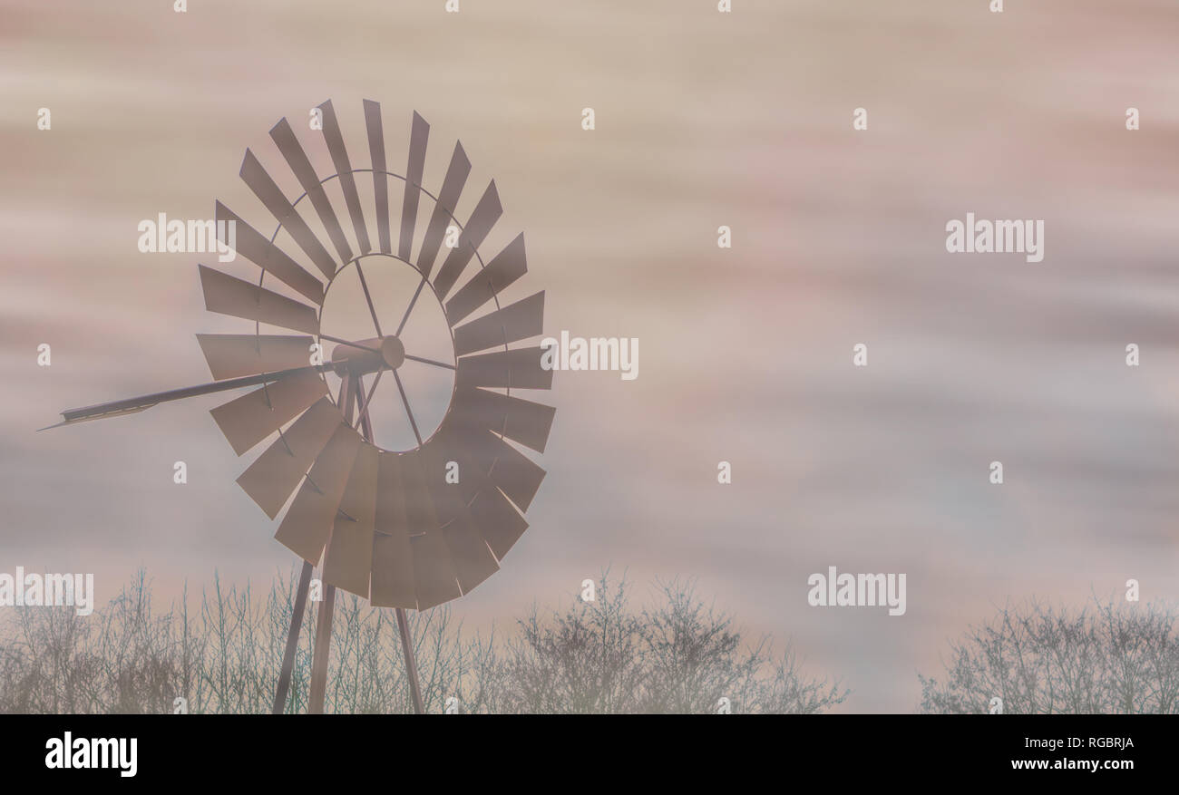 a old vintage rusty windmill in the mist, classical landscape ...