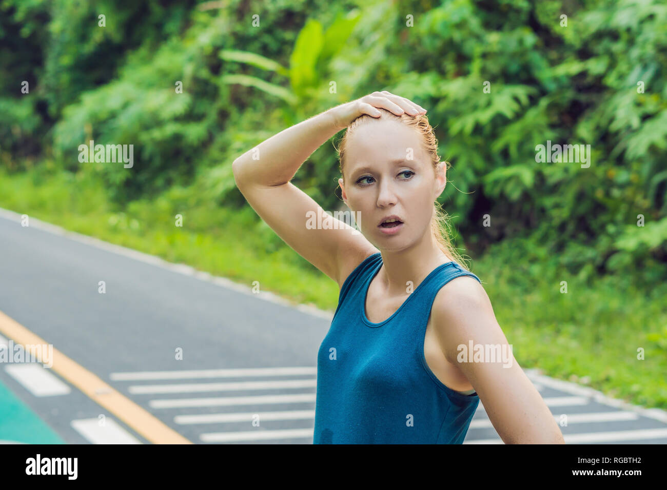 Tired runner sweating after running hard in countryside road. Exhausted ...