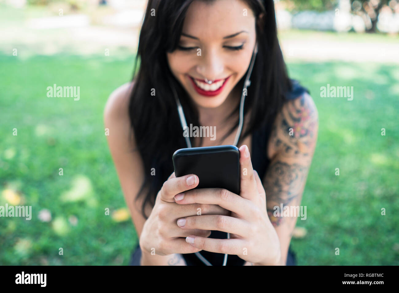Hands of smiling young woman holding smartphone Stock Photo - Alamy