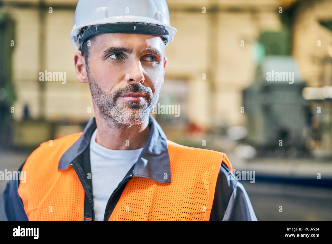 Portrait of man in factory looking around Stock Photo - Alamy