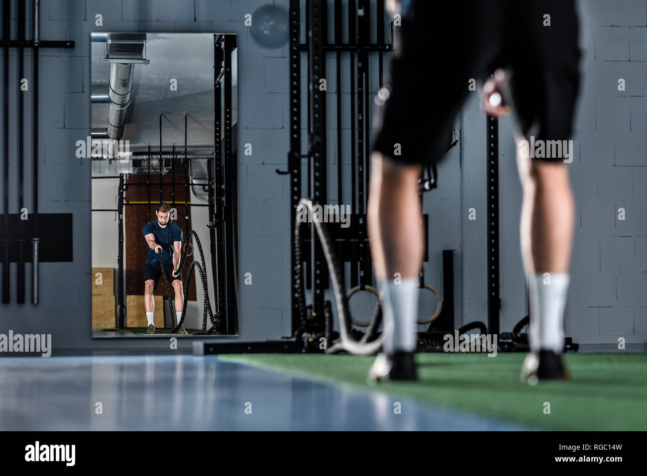 Man battle ropes hi-res stock photography and images - Alamy