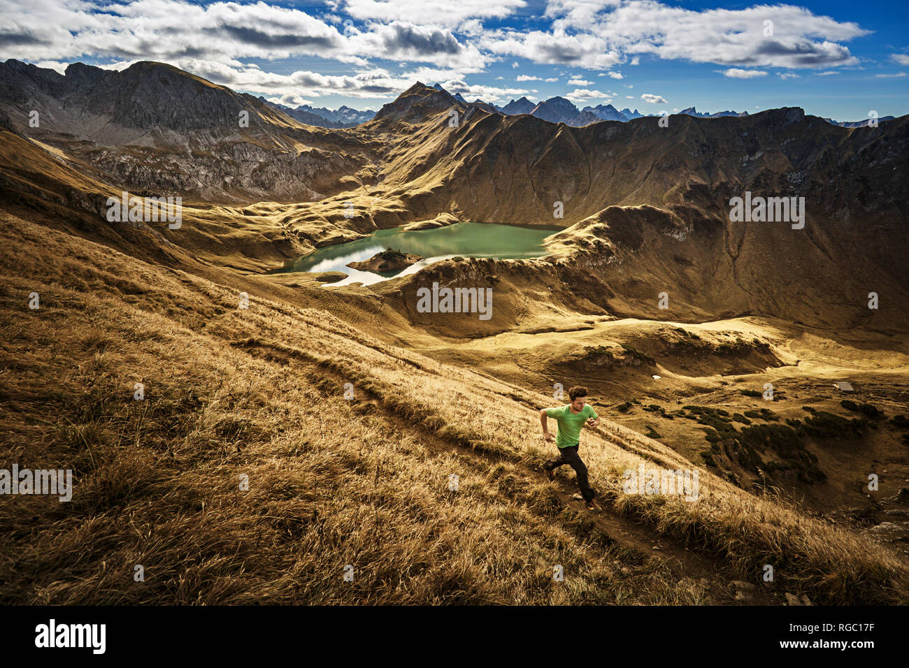 Germany, Allgaeu Alps, man running on mountain trail Stock Photo - Alamy