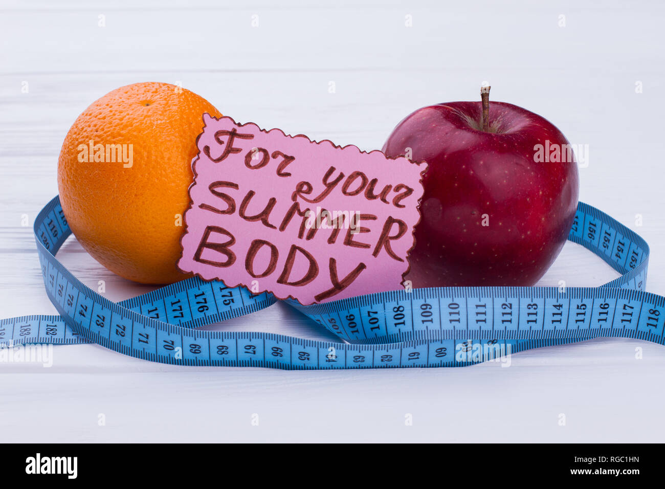 Healthy eating and slimming concept. Tape measure wrapped around fresh ...