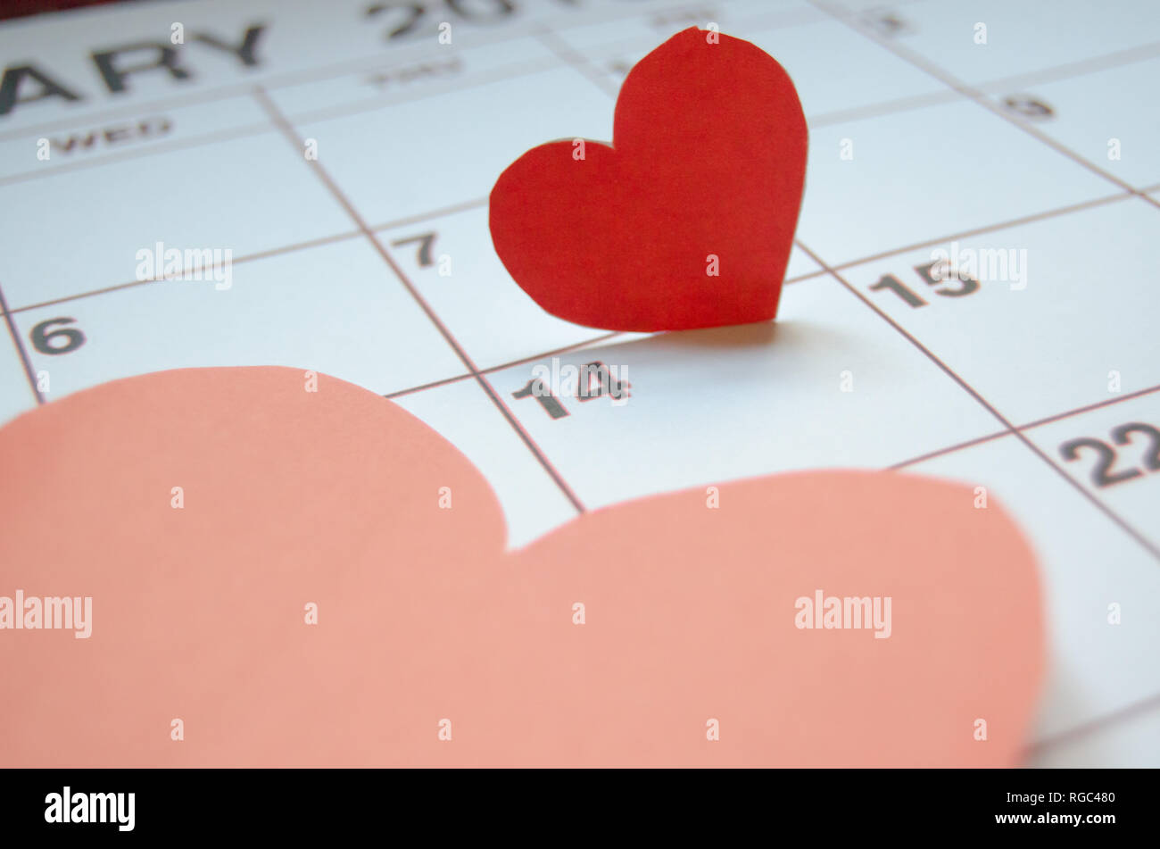 Paper red hearts marking 14 february Valentines day on white calendar ...