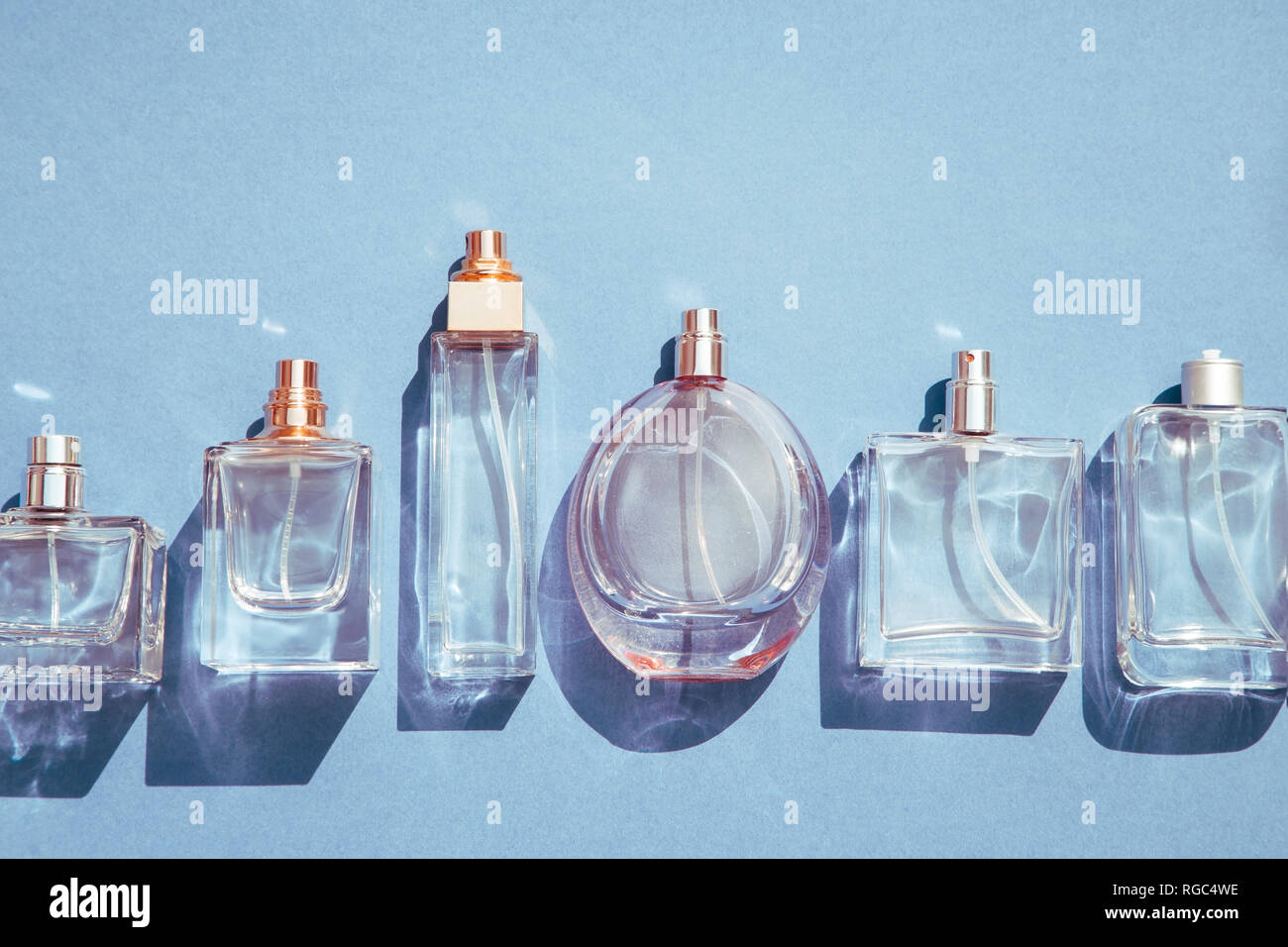 Collection of the various perfume bottles on blue background Stock ...
