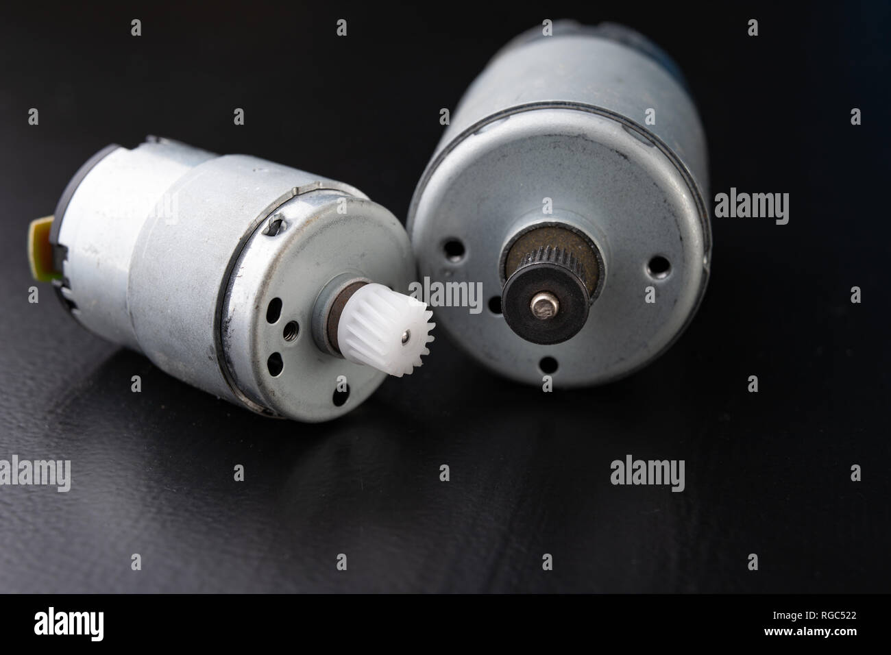 Small electric engine on a wooden dark table. Electric drive for small ...