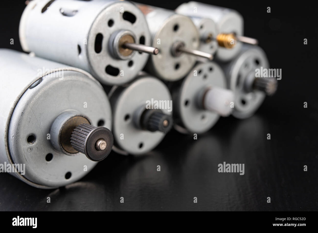 Small electric engine on a wooden dark table. Electric drive for small ...