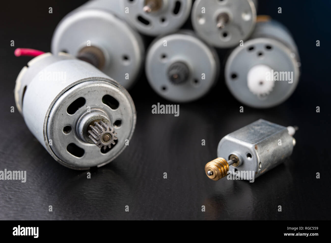 Small electric engine on a wooden dark table. Electric drive for small ...