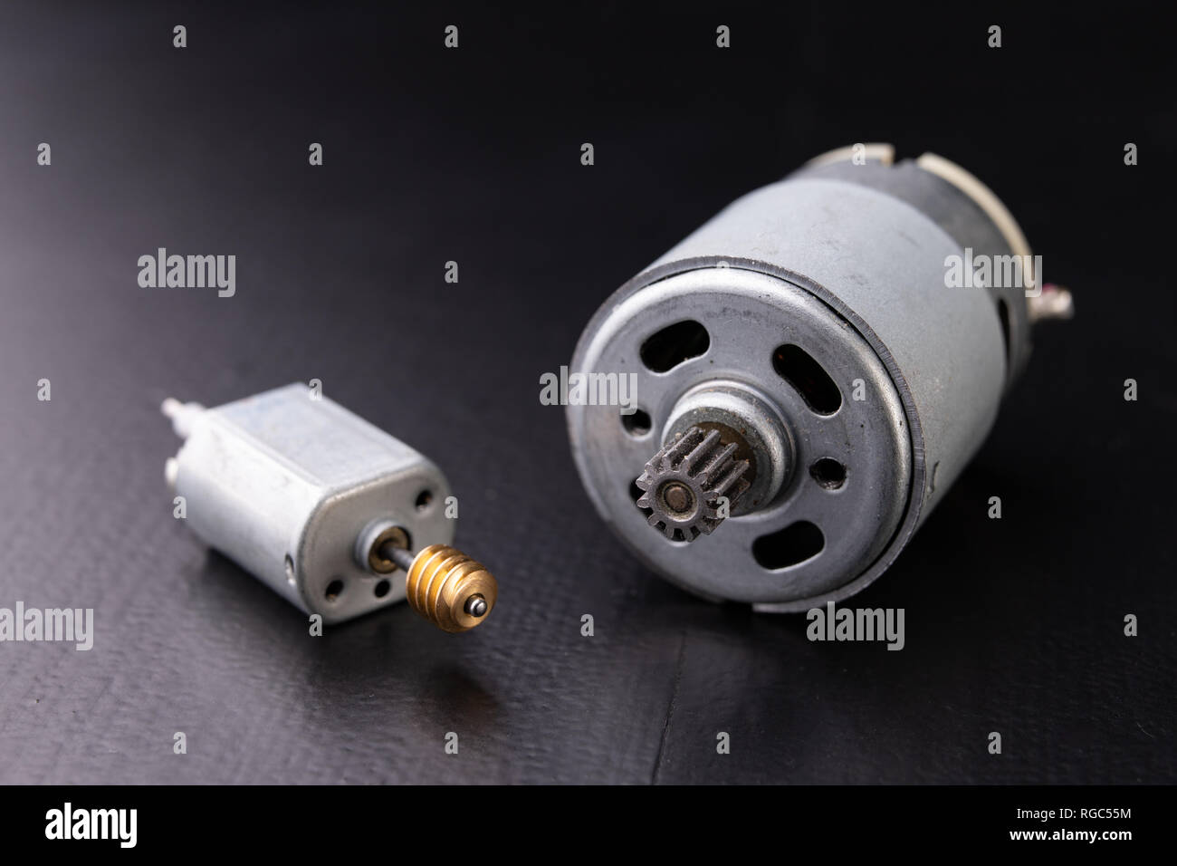 Small electric engine on a wooden dark table. Electric drive for small ...