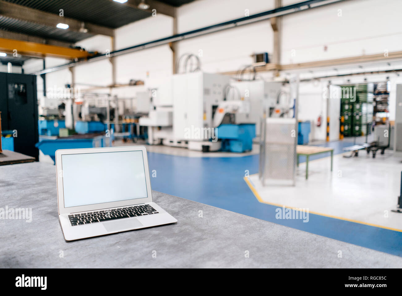 Laptop with blank screen in factory workshop Stock Photo - Alamy