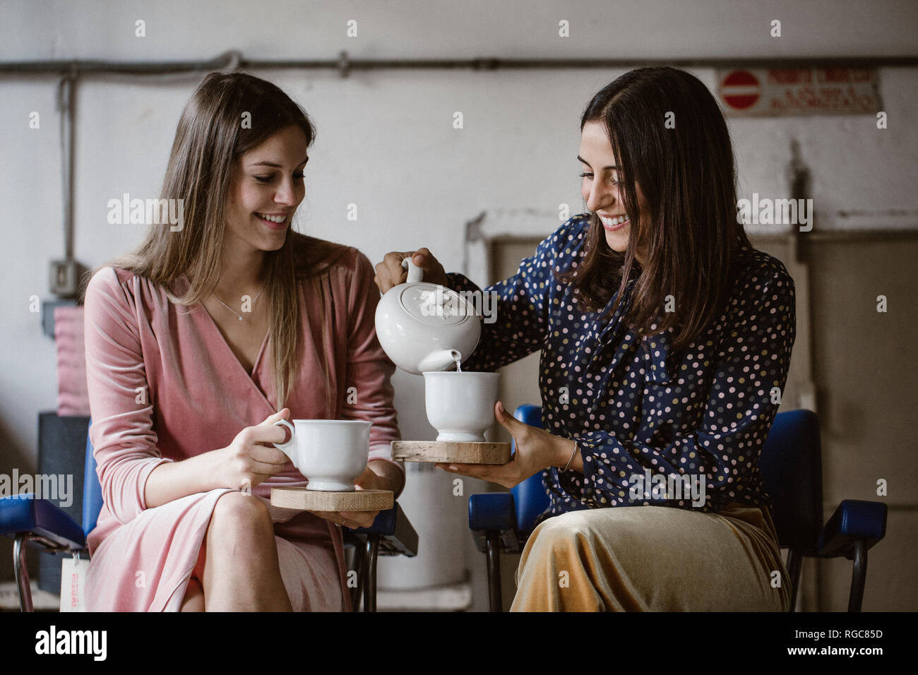 Two friends drinking tea together in a loft Stock Photo - Alamy