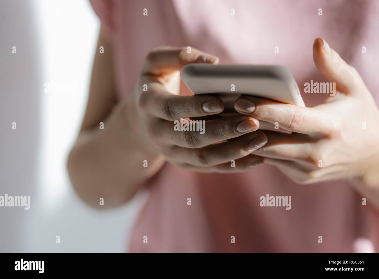 Casual young woman text messaging in a bright office Stock Photo - Alamy