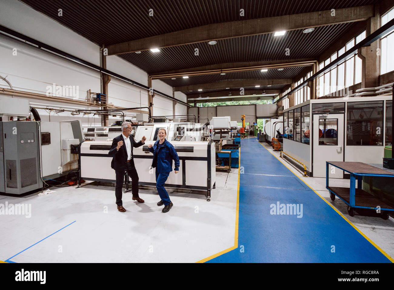 Manager skilled worker dancing factory workshop hi-res stock ...