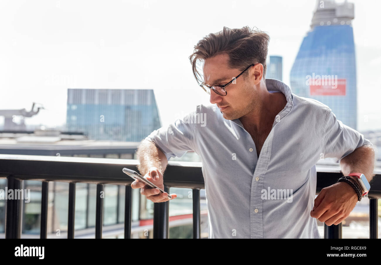 Man using cell phone roof terrace hi-res stock photography and images ...