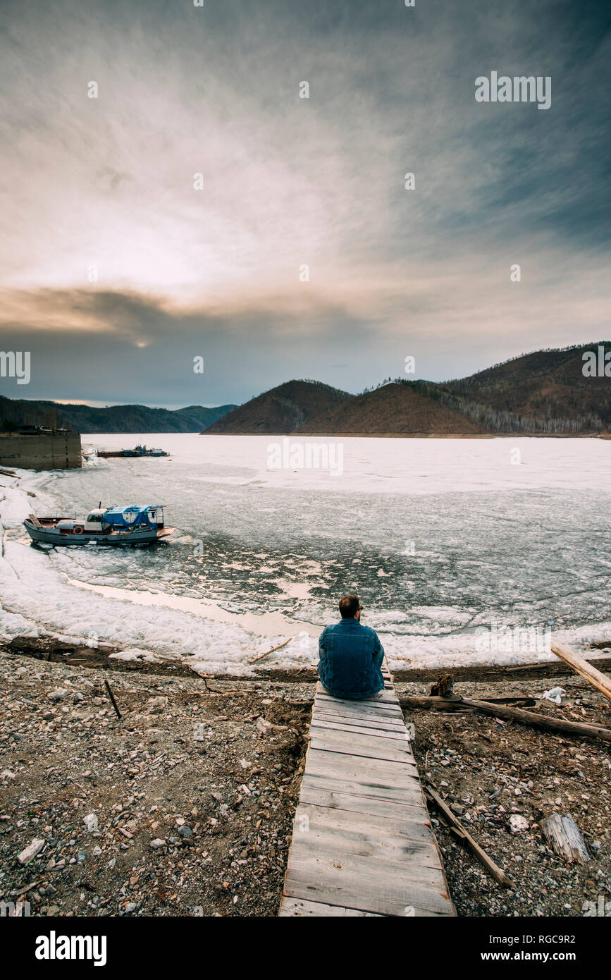Back man sitting boardwalk looking view hi-res stock photography and ...