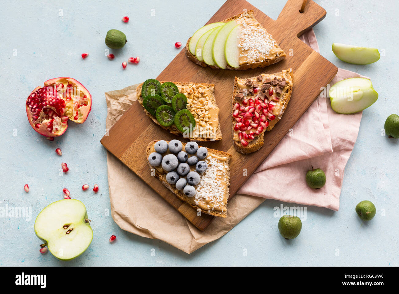 Bread slices with various toppings on wooden board Stock Photo - Alamy