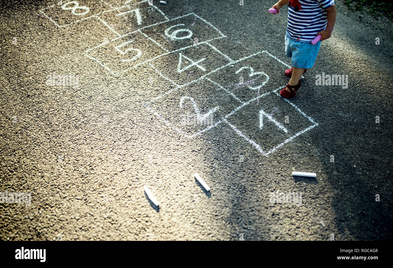 Little girl with drawn hopscotch on the street, partial view Stock ...