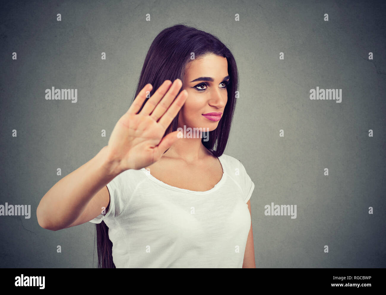 Portrait of an angry woman with bad attitude giving talk to hand ...
