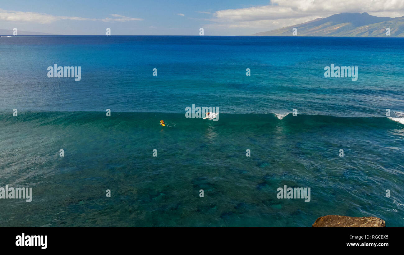 a surfer rides a longboard at honolua bay, maui in hawaii Stock Photo ...