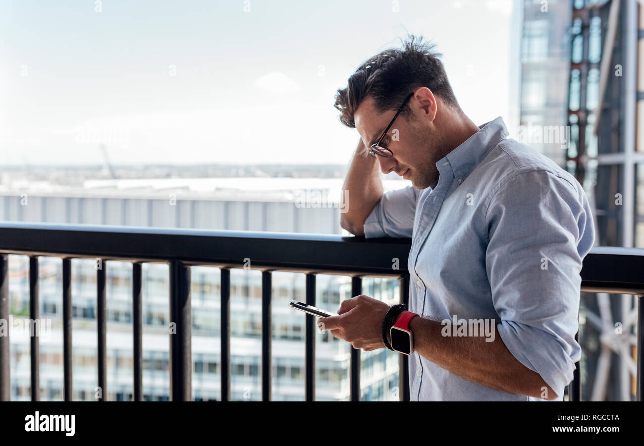 Man using cell phone roof terrace hi-res stock photography and images ...