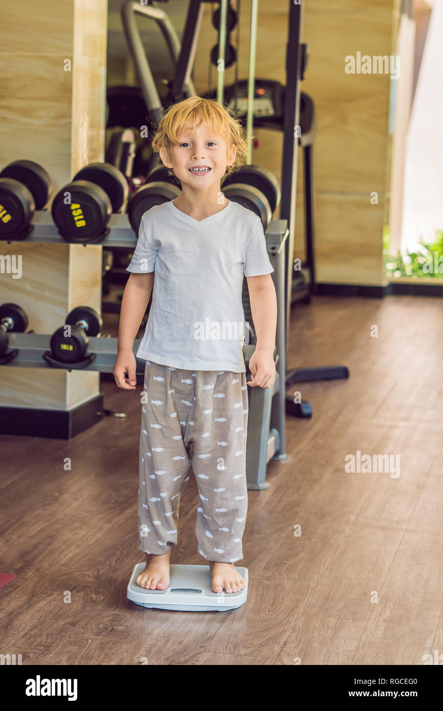 The boy stands on the scales to find out his weight Stock Photo - Alamy