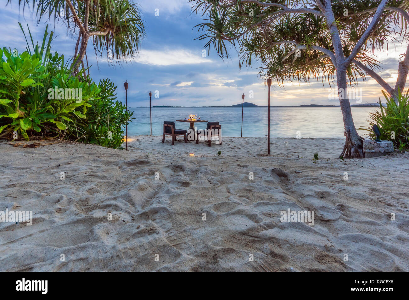 Indonesia, Riau Islands, Bintan, table at the beach in the evening ...