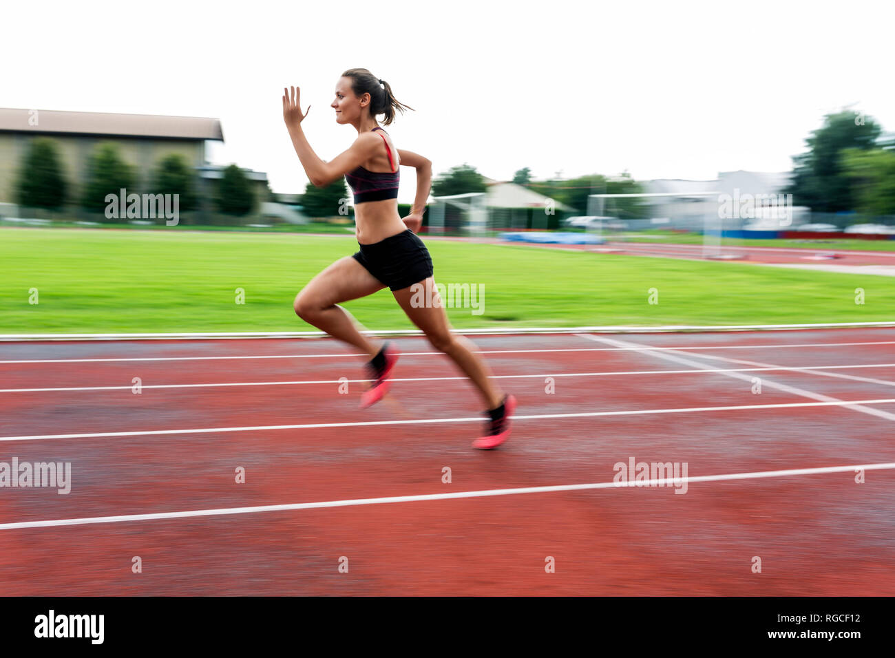 Teenage runner training on race track Stock Photo - Alamy