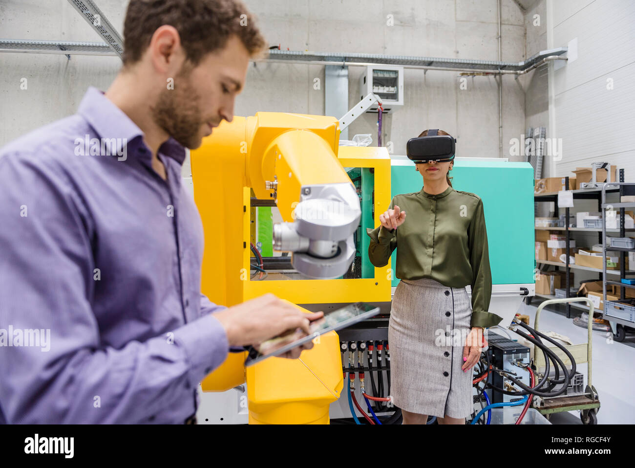 Colleagues in high tech company testing new technologies, using digital ...