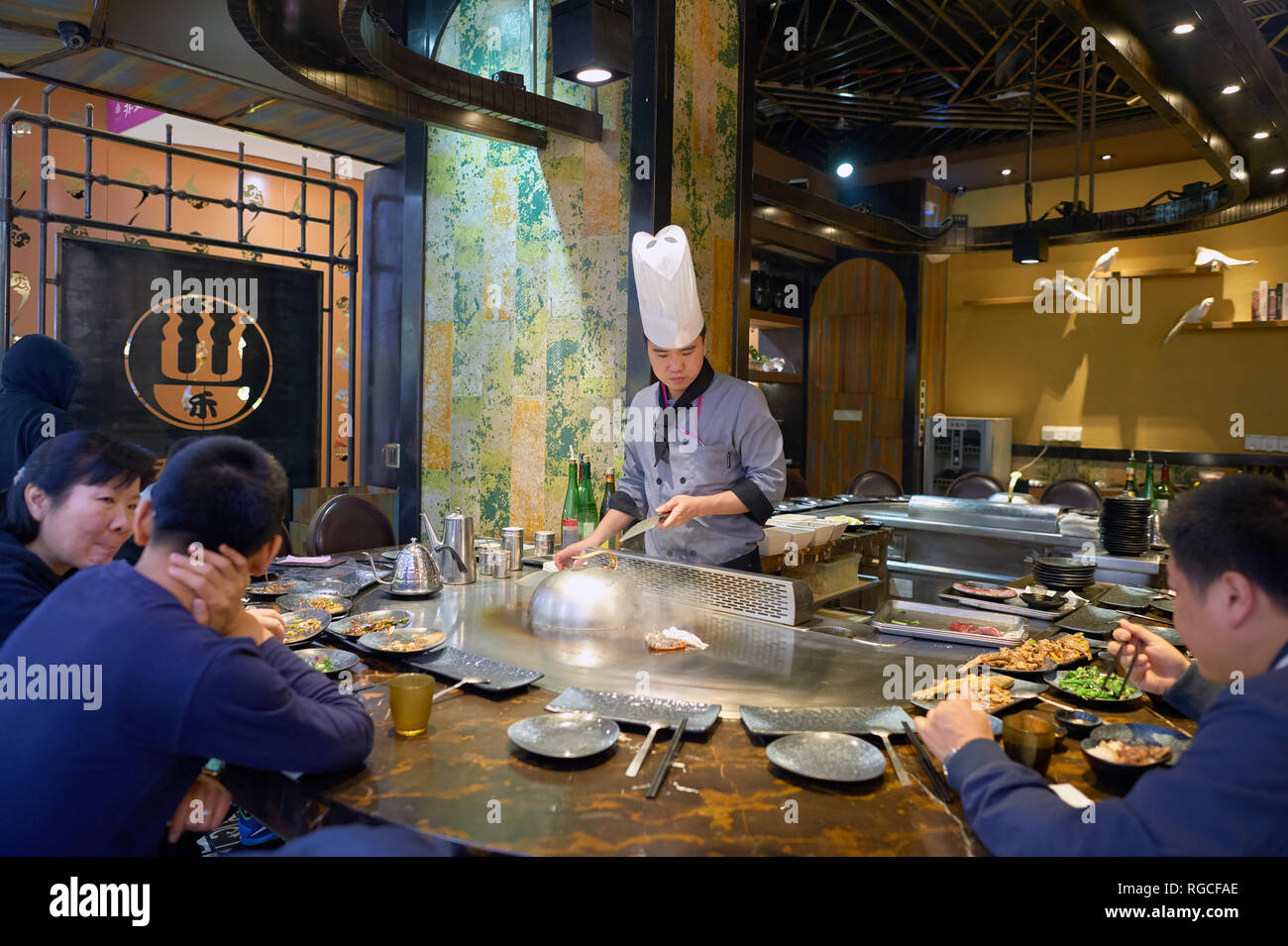SHENZHEN, CHINA - CIRCA DECEMBER, 2015: cook prepare food in a ...