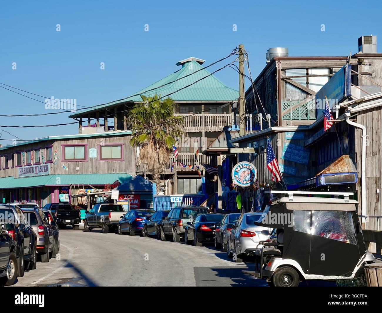 Cars parked along one way street in front of businesses/restaurants on ...
