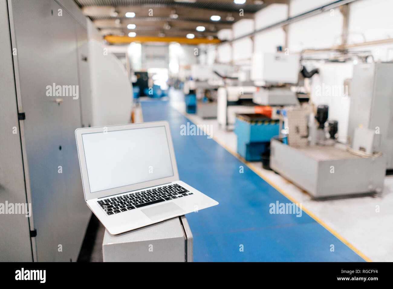 Laptop with blank screen in factory workshop Stock Photo - Alamy