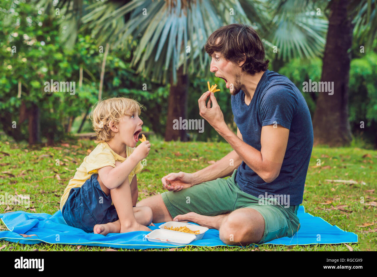 Cute healthy preschool kid boy eats french fries potatoes with ketchup ...