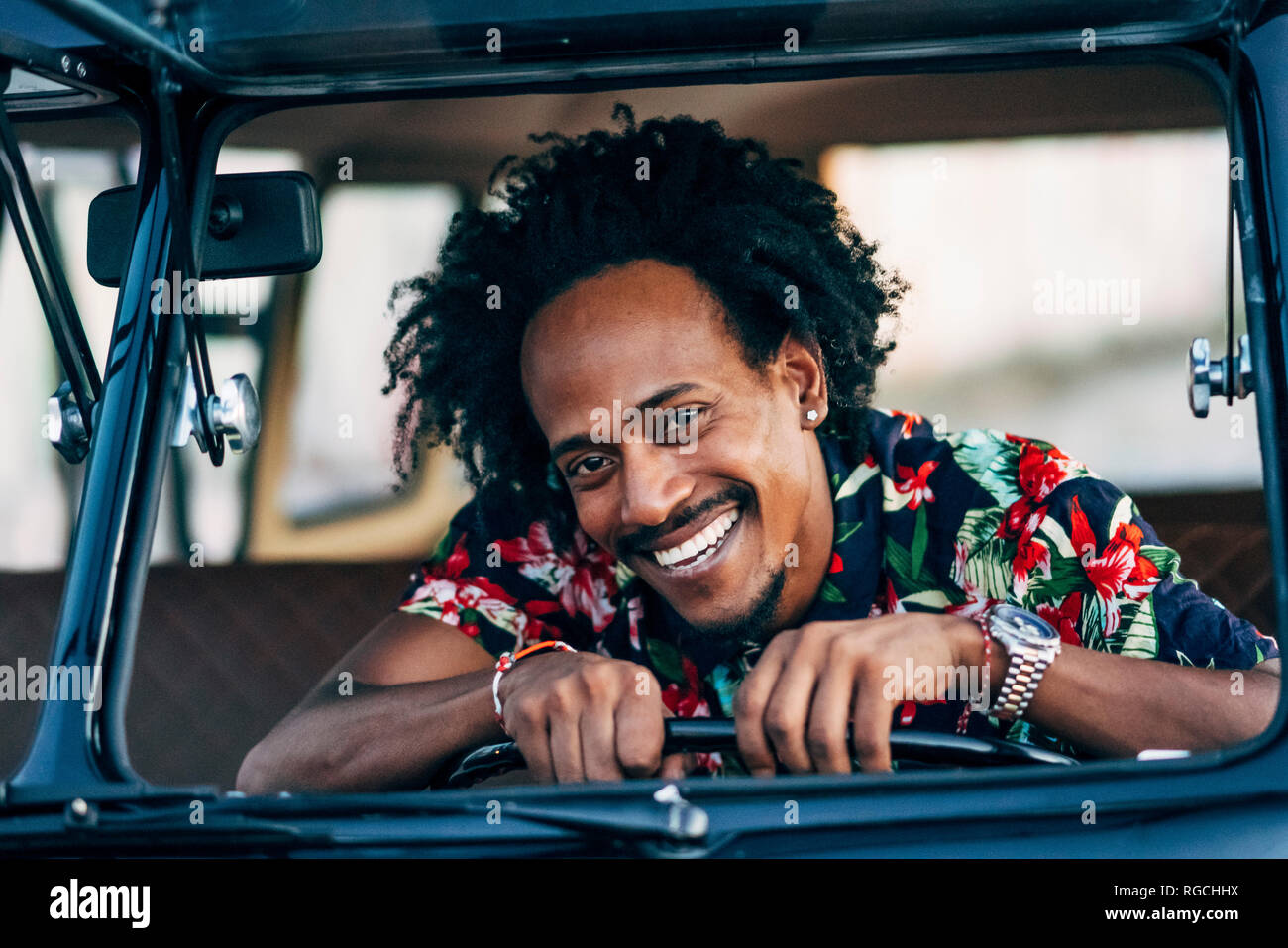 Portrait of laughing man looking out of car window Stock Photo - Alamy