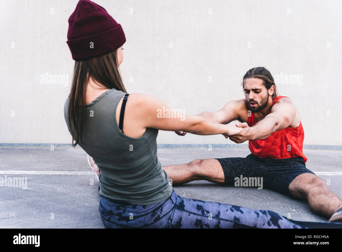 Fit young couple doing partner exercises Stock Photo - Alamy