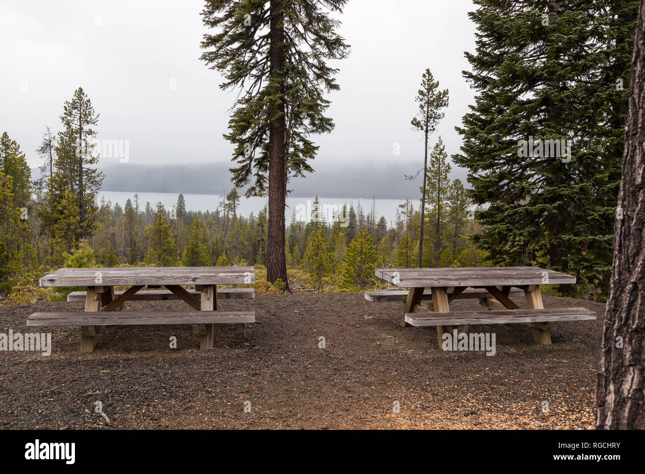 Two wooden picknic tables at a viewing area with Diamond Lake in the ...