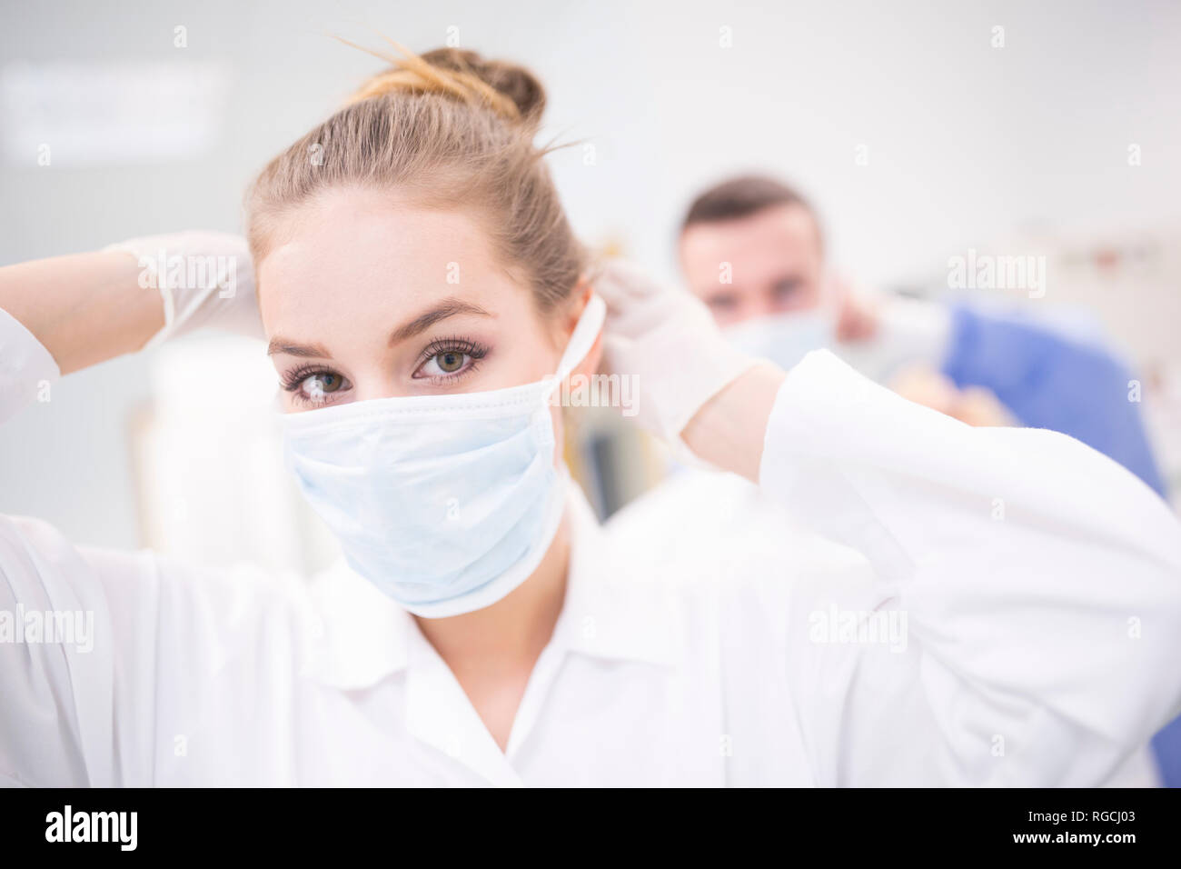 Woman putting on mask up hi-res stock photography and images - Alamy