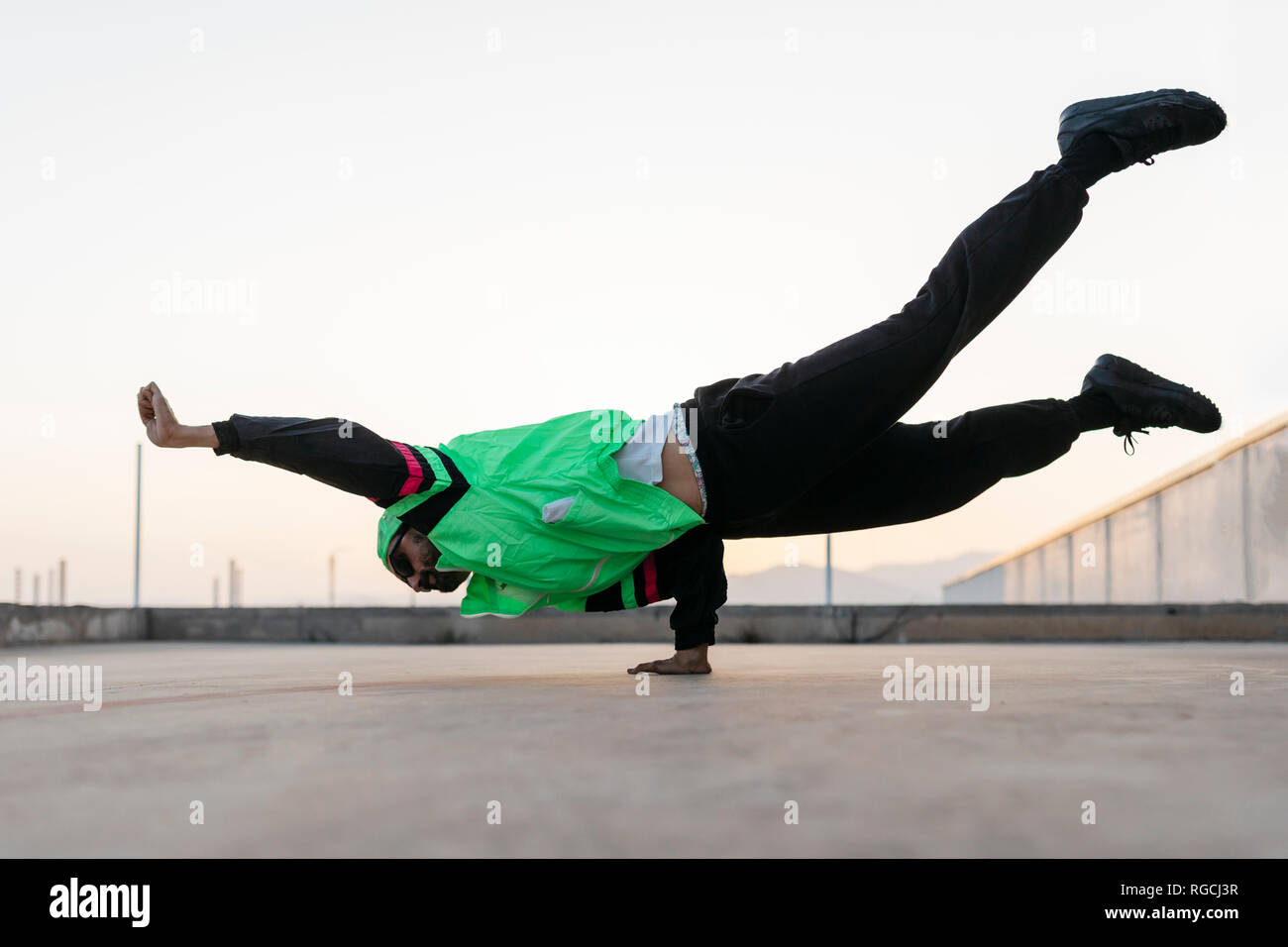 Man doing breakdance in urban concrete building, standing on hand Stock ...