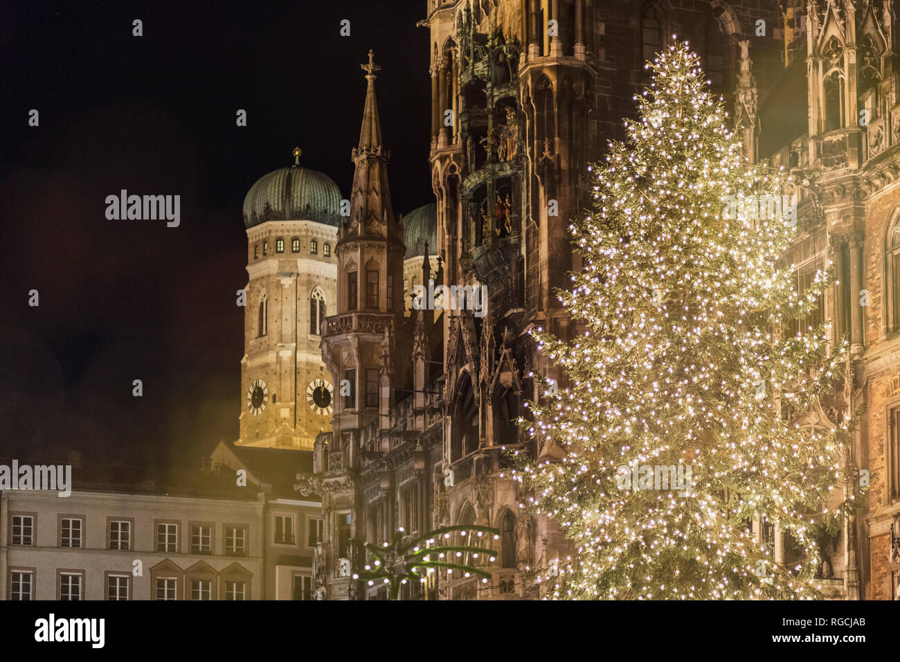 Germany, Munich, bright shining Christmas tree in front of old town ...