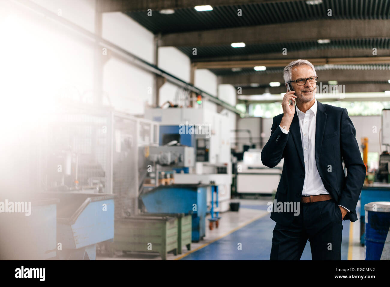 Manager talking on the phone in high tech company Stock Photo - Alamy