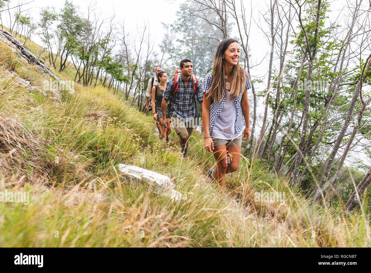 Italy, Massa, group of young people hiking in the Alpi Apuane mountains ...