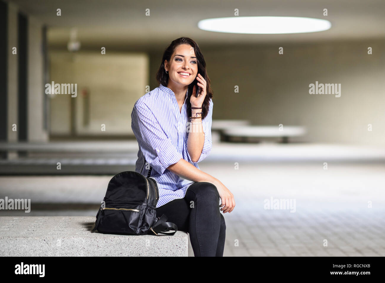 Portrait of smiling student on the phone Stock Photo - Alamy