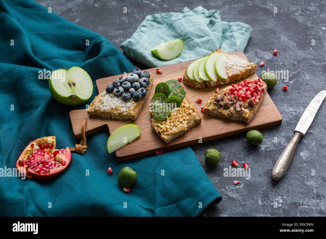 Bread slices with various toppings on wooden board Stock Photo - Alamy