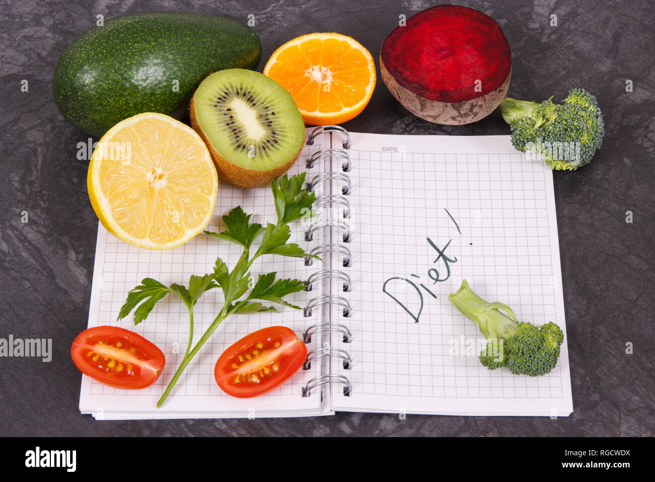 Word diet written in notepad and fresh ripe fruits with vegetables ...