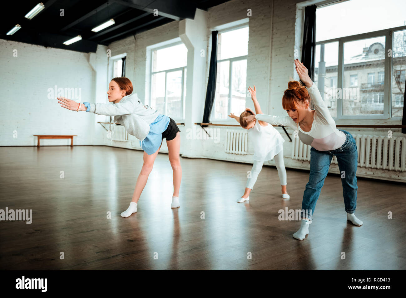 Professional modern dance teacher with red hair giving a lesson in the ...