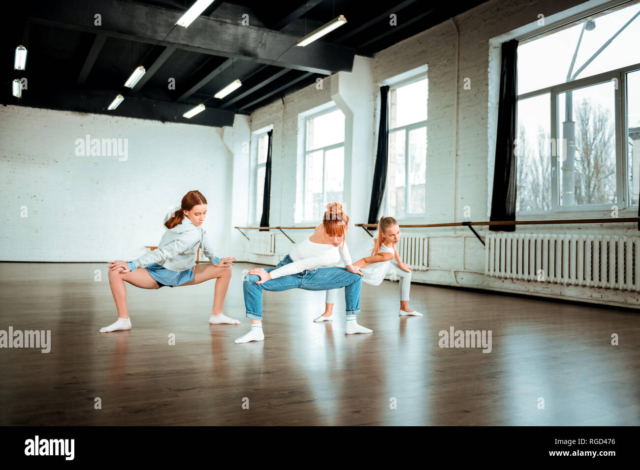 Slim beautiful ballet teacher with red hair looking involved Stock ...