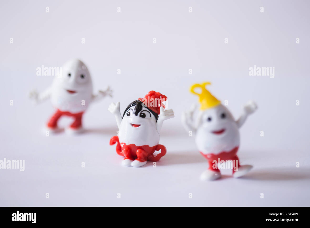 Three dancing mini egg toys on white background Stock Photo - Alamy