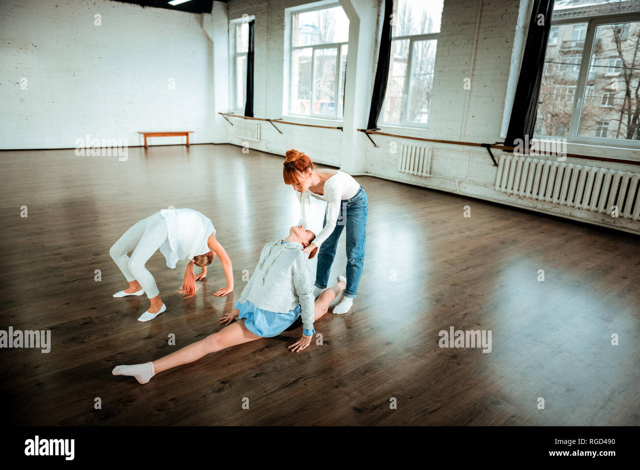 Dark- haired girl from generation z working out legs-split Stock Photo ...