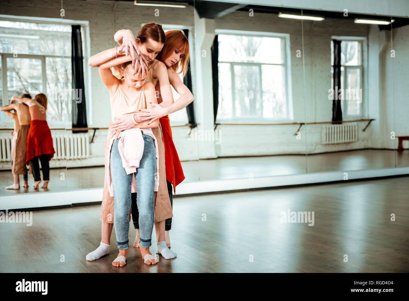 Red-haired young dance teacher and her students working together Stock ...